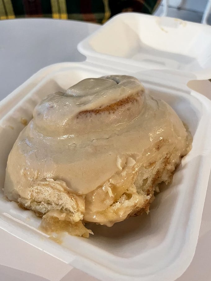 Evidence that someone in Winston-Salem understands the architecture of joy. Half-eaten yet fully appreciated, this cinnamon roll reveals its perfectly layered interior.