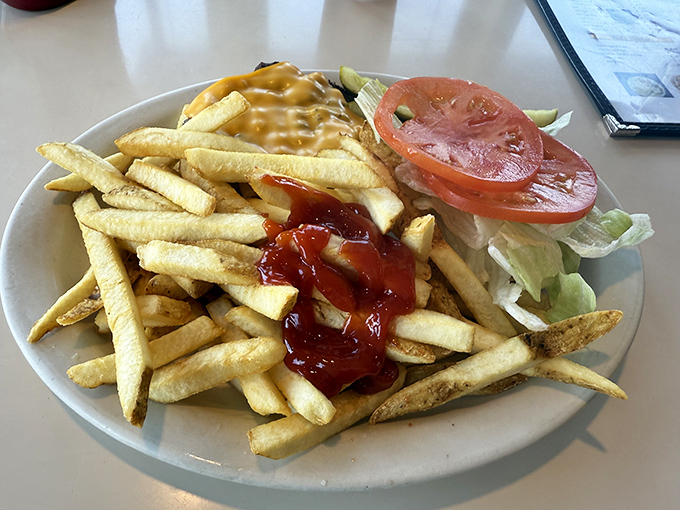 French fries dressed for success with cheese sauce and ketchup&mdash;the kind of guilty pleasure that makes you temporarily forget vegetables exist.
