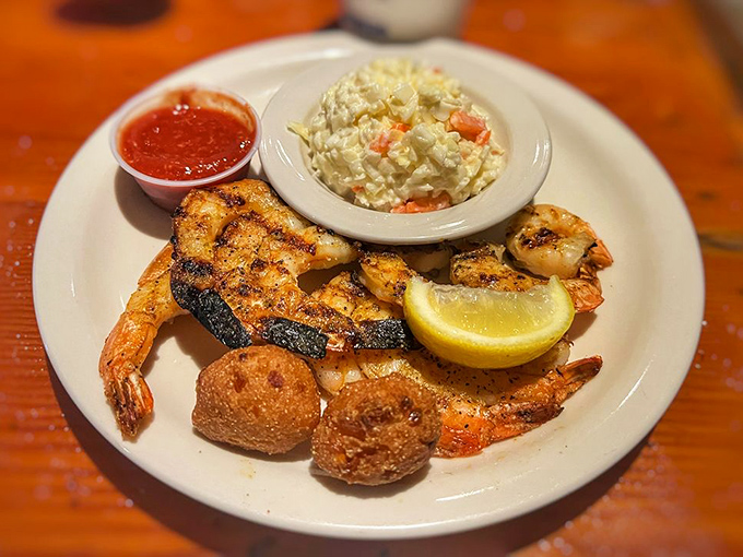 Blackened shrimp that's seen just enough heat to get interesting, paired with creamy coleslaw and hush puppies that demand your attention.