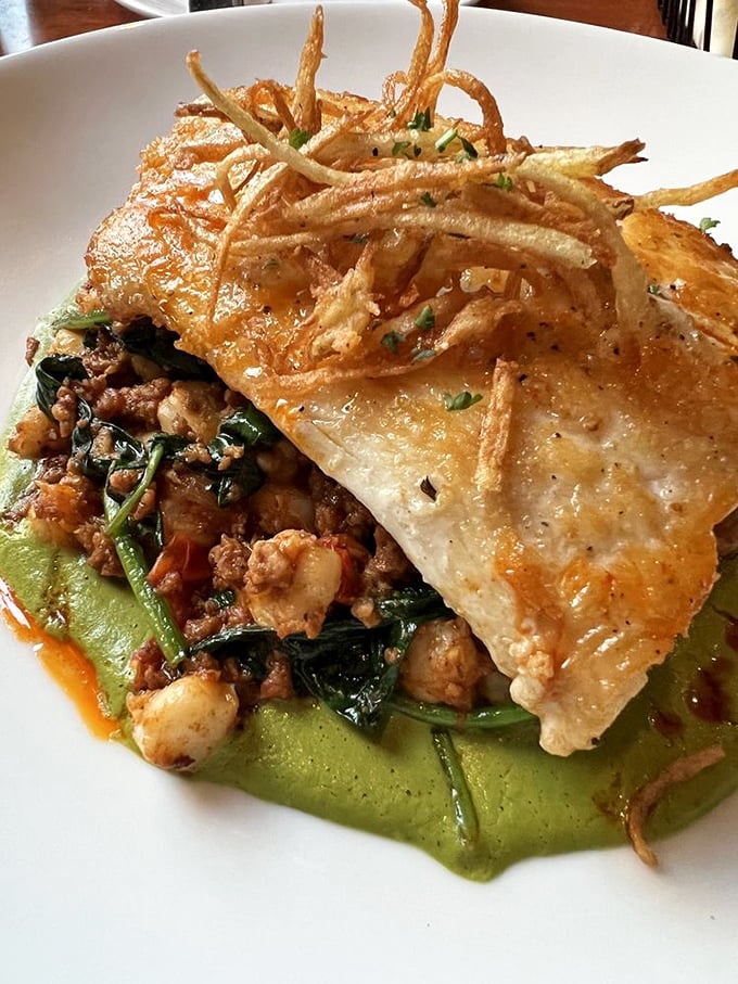 Not just fish, but an edible art installation. Crispy exterior giving way to tender flakes, all atop a vibrant canvas of flavor. 