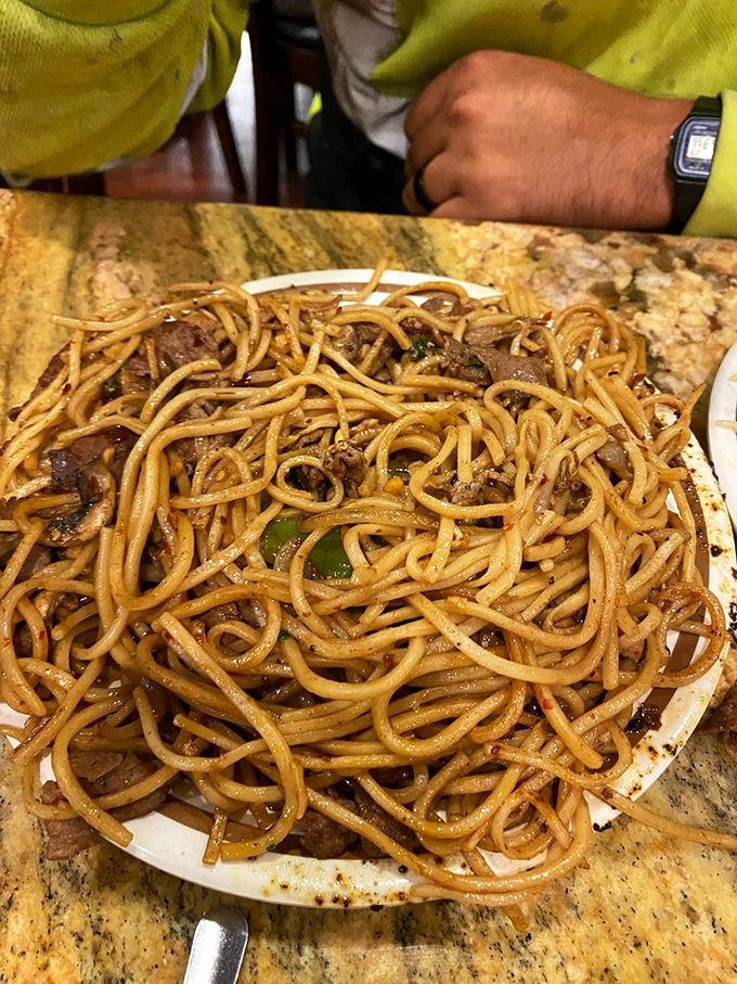Lo mein noodles that could stretch from Montclair to San Francisco, glistening with a sauce worth every potential shirt stain.