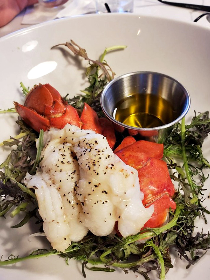 Ocean-to-table perfection: sweet lobster meat and tender claw arranged like jewelry on a bed of greens. Neptune himself couldn't have designed a more beautiful seafood presentation.