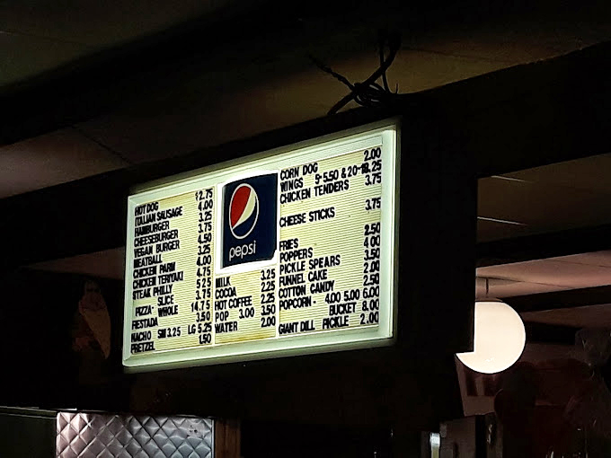 The illuminated menu board&mdash;a glowing testament that drive-in cuisine has evolved far beyond the humble popcorn kernel.
