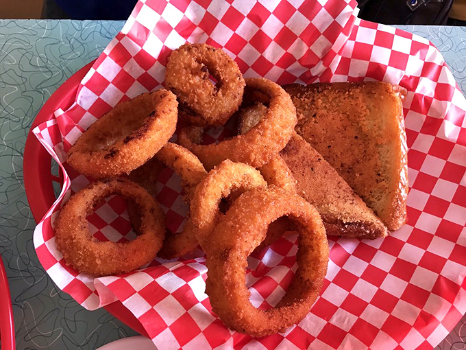 Golden-brown onion rings that shatter with each bite, paired with cornbread that would make your grandmother nod in approval. Crunch time, deliciously defined.