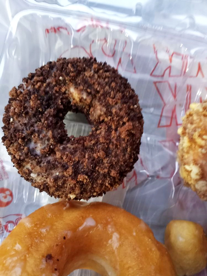 This chocolate-crusted beauty isn't just a donut – it's what cookies and cream dreams about becoming when it grows up. Worth every delicious calorie.