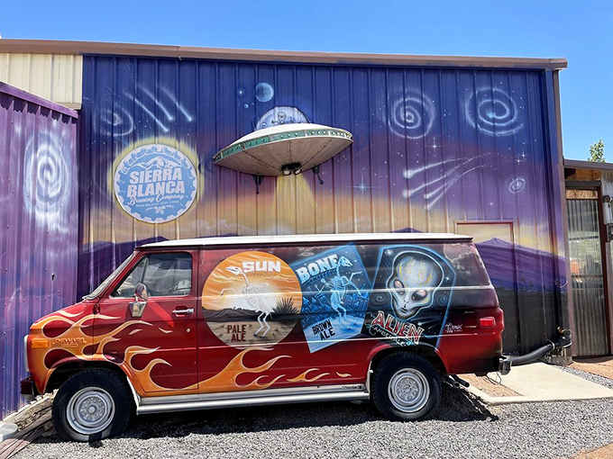 The brewery's alien-themed delivery van sits beneath a cosmic mural. Even extraterrestrials know where to find the good stuff in New Mexico.