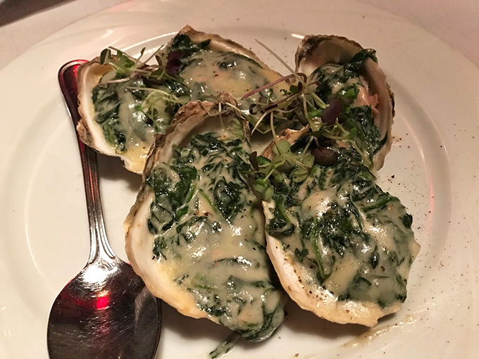 These aren't just oysters – they're little ocean jewels, dressed in their spinach-cream finest for their grand Pennsylvania mountain debut.