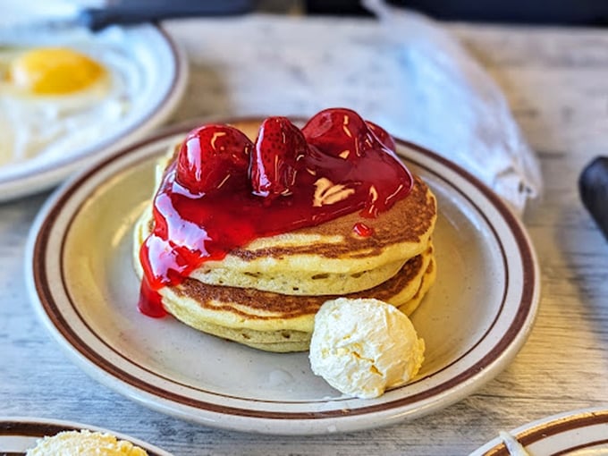 Pancakes crowned with cherry topping and a dollop of butter&mdash;proof that sometimes the simplest pleasures are worth getting out of bed for.