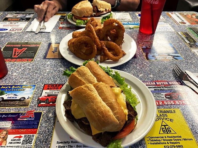 This isn't just a sandwich&mdash;it's an architectural marvel of crispy onion rings and perfectly stacked ingredients that requires both hands and a strategy.