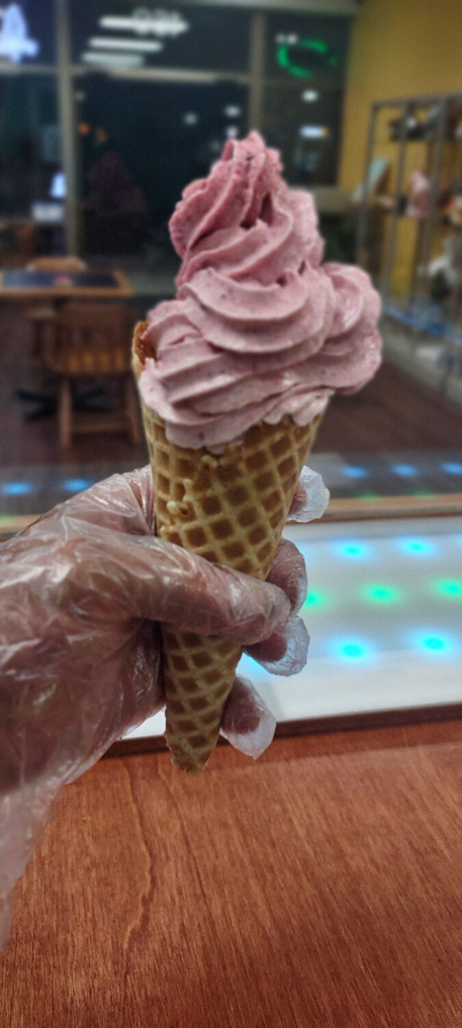 Pink perfection swirls atop a golden cone. This raspberry creation isn't just ice cream – it's summer captured in a hand-held format.