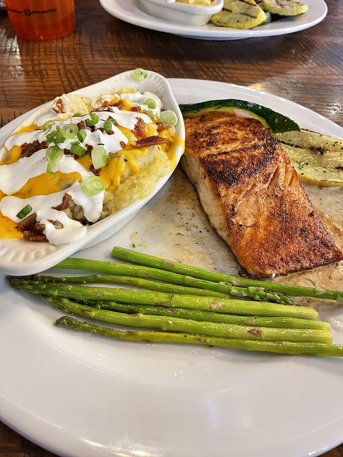 Salmon that could convert the most dedicated landlubber. That perfect sear, those vibrant asparagus spears, and is that loaded mashed potatoes I spy?
