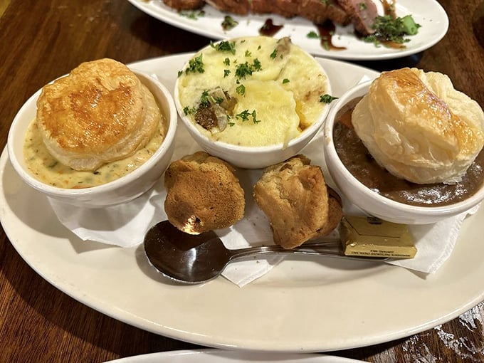 The holy trinity of Irish comfort: three savory pies crowned with golden pastry, flanked by homemade biscuits that deserve their own fan club. 