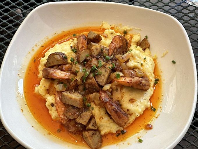 Shrimp and grits: the dish that makes Southerners nostalgic and Northerners jealous. That orange halo of sauce is pure flavor sunshine.