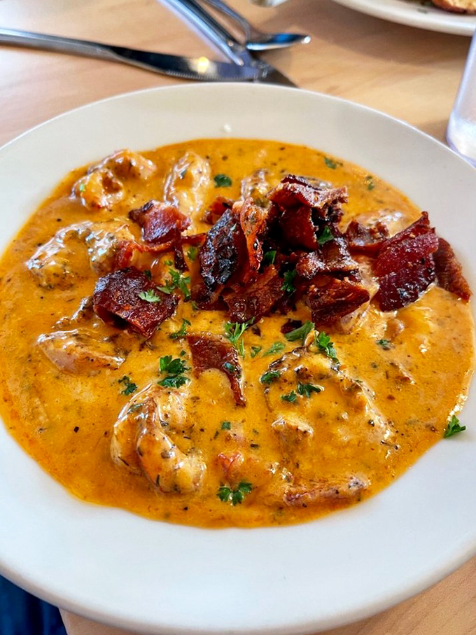 Shrimp swimming in a sea of creamy grits with bacon islands—a Southern classic that feels like a warm hug for your taste buds.