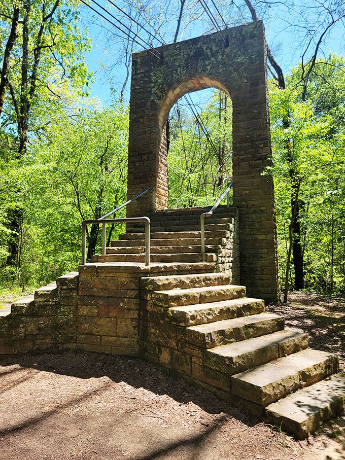 Water whispers over ancient stone, creating nature's shower. This hidden waterfall grotto offers cool refuge on Mississippi's steamiest summer days. 