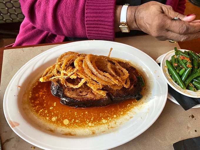 Southern hospitality on a plate: a succulent steak swimming in savory jus, accompanied by green beans that actually make vegetables exciting again.