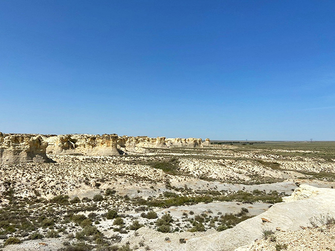 The badlands stretch toward infinity under that impossibly blue Kansas sky&mdash;a landscape that makes you question whether you're still in the Sunflower State.