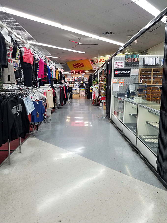 Fluorescent lights illuminate a wonderland of possibilities, where audio equipment shares space with fashion finds.