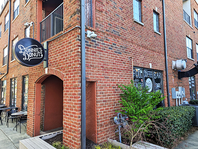 Donnie's Donuts' corner brick location with its understated black sign whispers rather than shouts &ndash; confident its treats speak volumes.