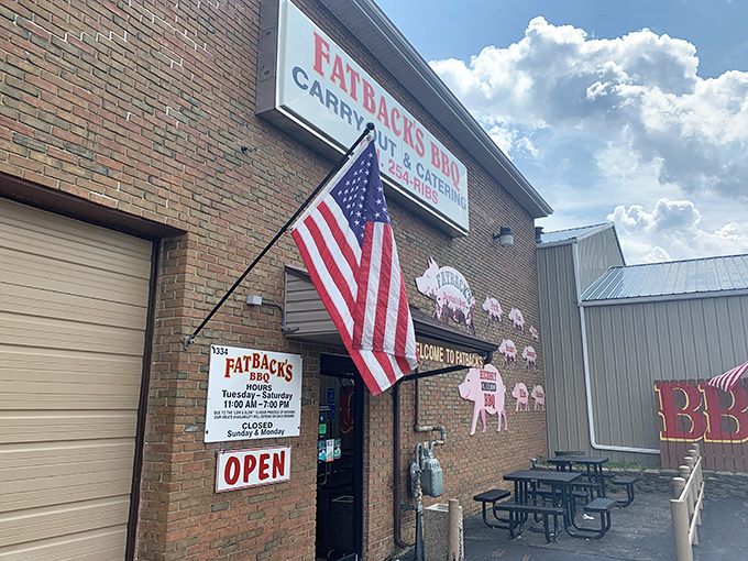 Fatback's patriotic entrance sets the tone for all-American BBQ excellence. That flag flies proudly over some seriously good smoked meats.