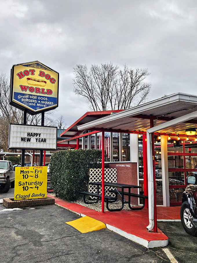 Hot Dog World's cheerful signage makes a bold claim that their kitchen happily backs up with every perfectly dressed dog.
