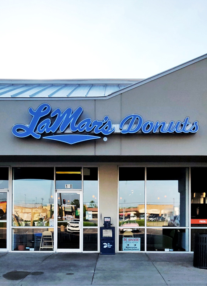 LaMar's sleek blue signage stands out like a sapphire in a jewelry box. That script font practically whispers "these aren't grocery store donuts."