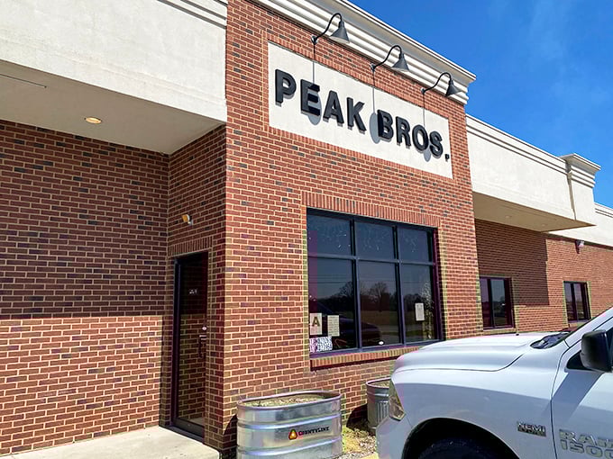 Peak Brothers' brick fa&ccedil;ade screams "no-nonsense BBQ inside." When simplicity meets smoke, magic happens on your plate!