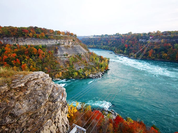 The mighty Niagara River carves through ancient rock, creating a swirling spectacle that hypnotizes all who dare to watch.