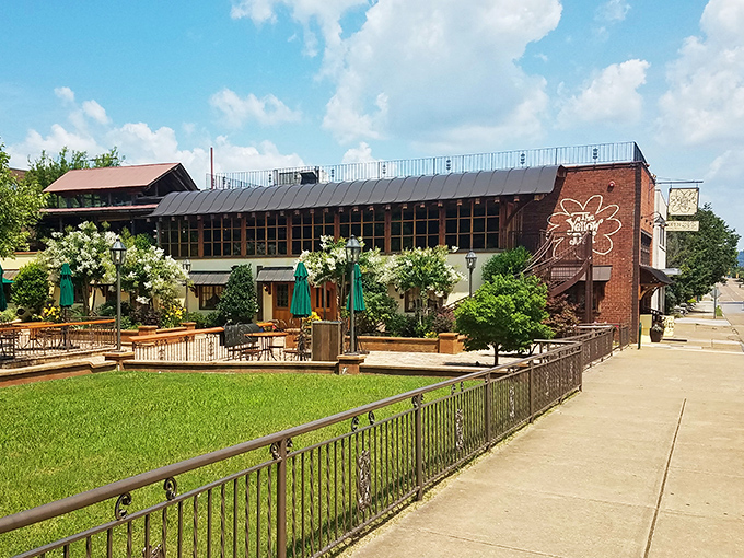 The Yellow Deli's brick-and-flower exterior feels like stumbling into a storybook where the happy ending is always a perfect sandwich.