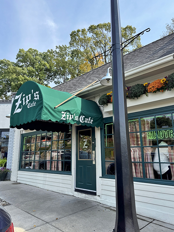 Zip's green awning signals burger paradise ahead, like a culinary oasis in Cincinnati's urban landscape.