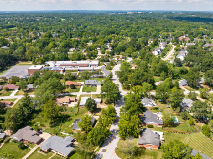 This aerial view showcases Ballwin's lush tree canopy and thoughtfully planned neighborhoods with homes at prices that won't leaf you broke.