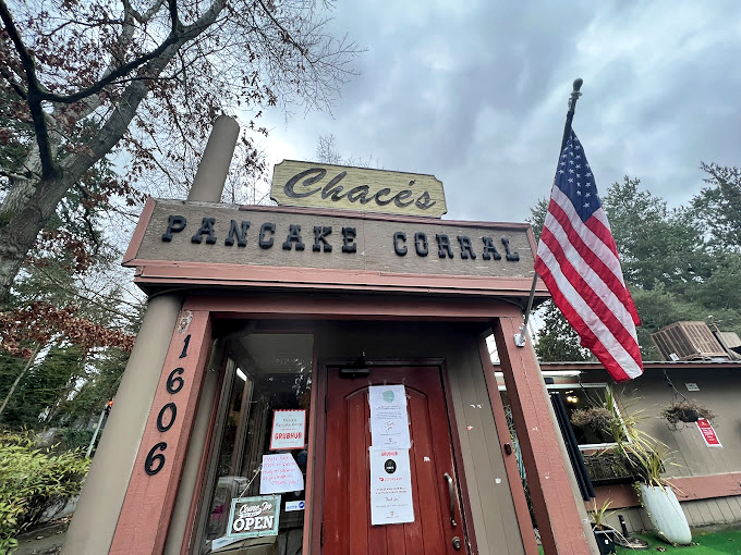 The Pancake Corral's wooden frontier charm stands defiant against Bellevue's modern skyline, a delicious time capsule.