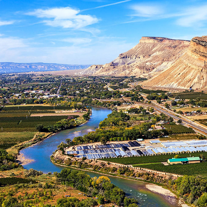 The Colorado River winds through Grand Junction like nature's blue ribbon, gift-wrapping a retirement destination that won't break the bank.