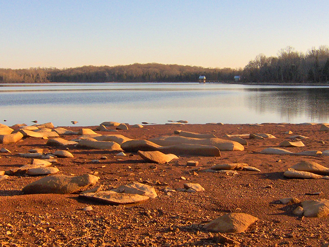 Fall at Long Hunter transforms ordinary trees into flame-dancers, their reflections doubling the spectacular show.