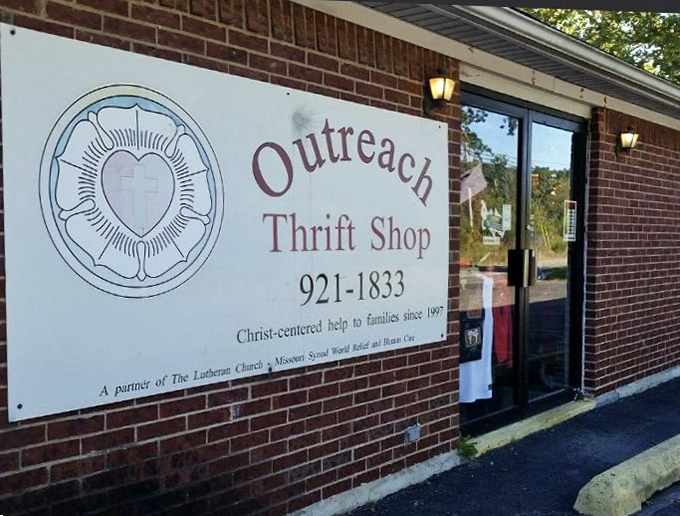 A closer look at Outreach Thrift Shop's sign reveals its mission of helping families while offering great deals since 1997.