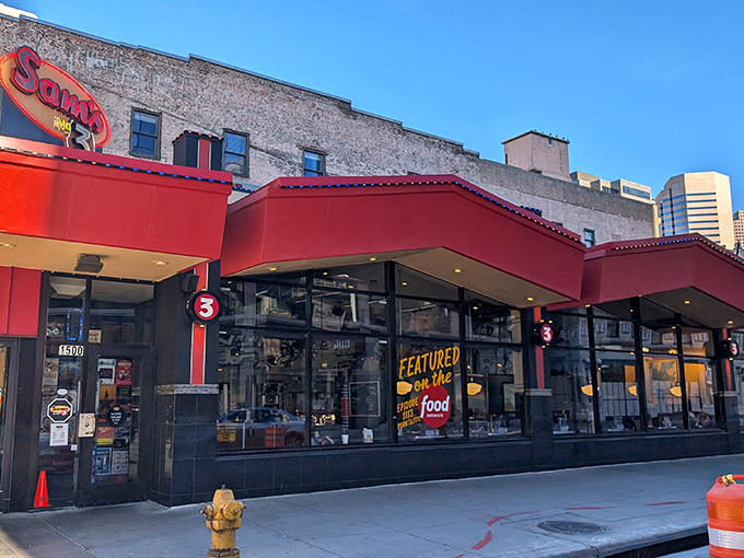 That iconic red-and-yellow awning at Sam's is like a superhero cape for a building that fights hunger crimes.