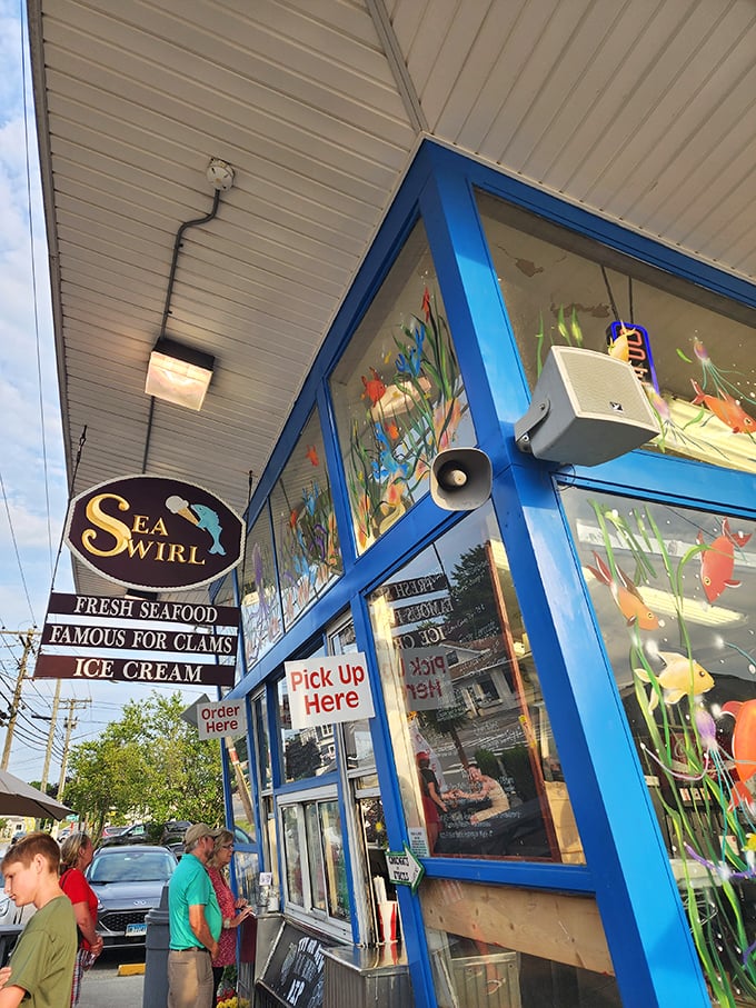 The blue-trimmed windows of Sea Swirl frame a world where ice cream and fried clams create perfect summer memories.