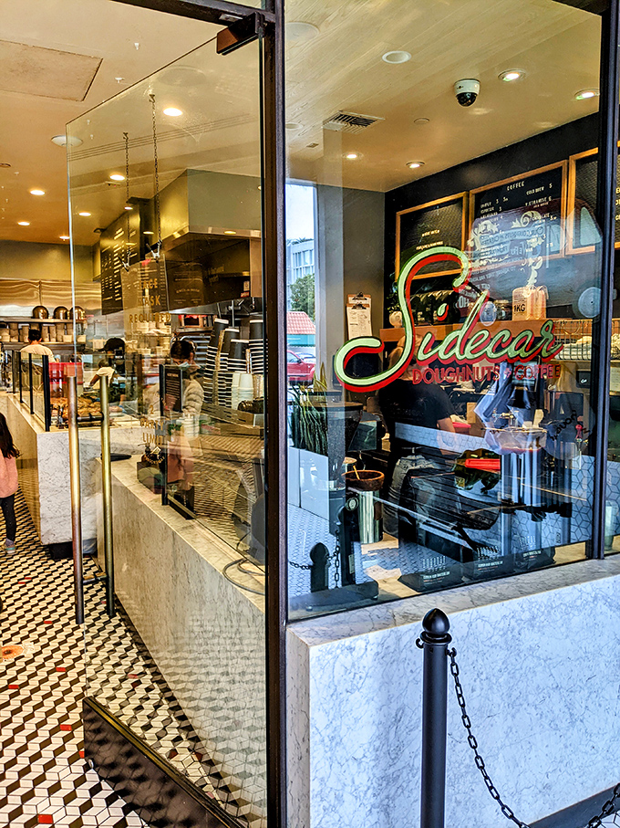 Through that gleaming window, you can watch culinary magic happen—fresh dough transformed into pillowy perfection every single hour.