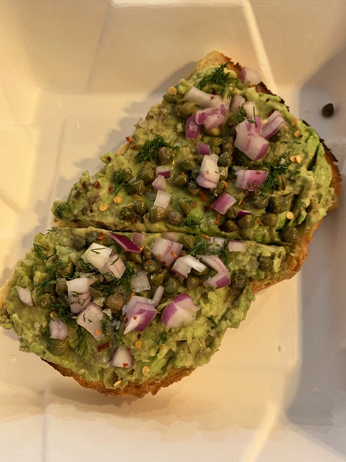 Avocado toast elevated to art form. Those red onions and capers aren't garnishes—they're the supporting actors in a culinary masterpiece.