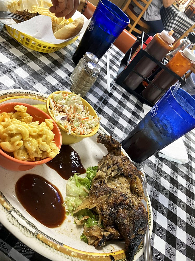 BBQ chicken with that blackened, spice-crusted exterior giving way to juicy meat beneath. The mac and cheese looks like it's plotting to steal the show.