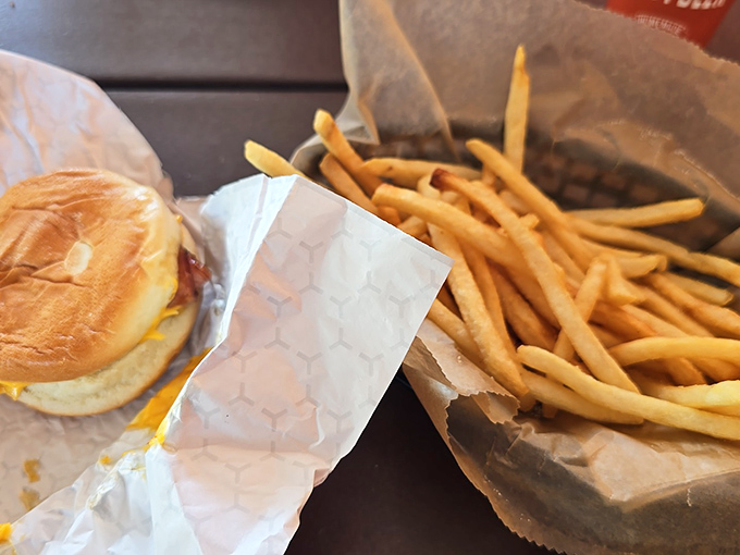 The dynamic duo of road trip dining: a perfectly compact burger paired with golden fries that practically beg to be dipped.
