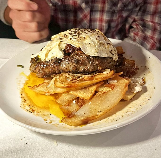 This isn't just food&mdash;it's a stack of pure joy. The egg breaks over the steak like sunshine after a storm, creating a sauce nature herself designed.