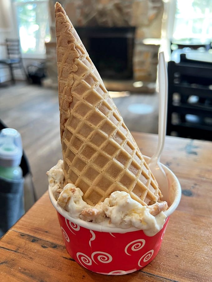 The waffle cone stands tall and proud, like the Washington Monument of desserts, cradling what appears to be cream-colored heaven with remarkable dignity.