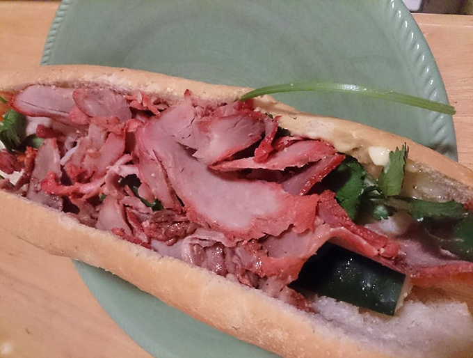 The shredded pork banh mi reveals its inner beauty&mdash;a symphony of textures where each bite tells a different delicious story. 