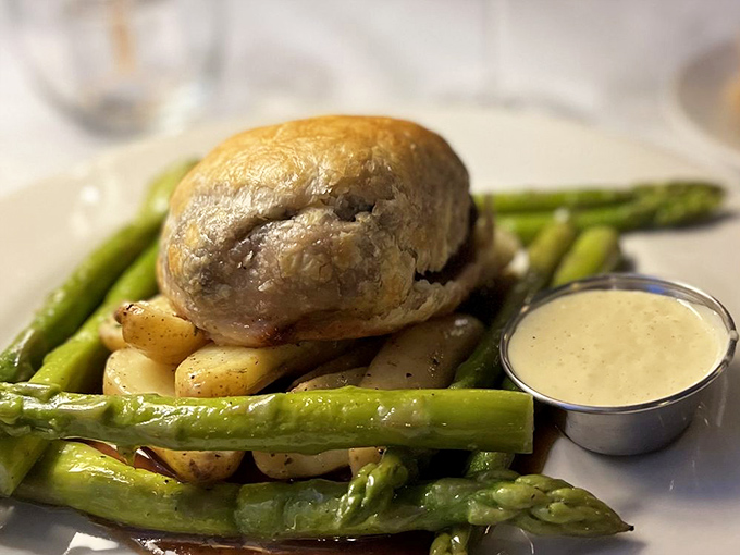 This isn't just beef Wellington&mdash;it's a masterclass in pastry-wrapped indulgence. The asparagus and sauce are supporting actors in this delicious drama.