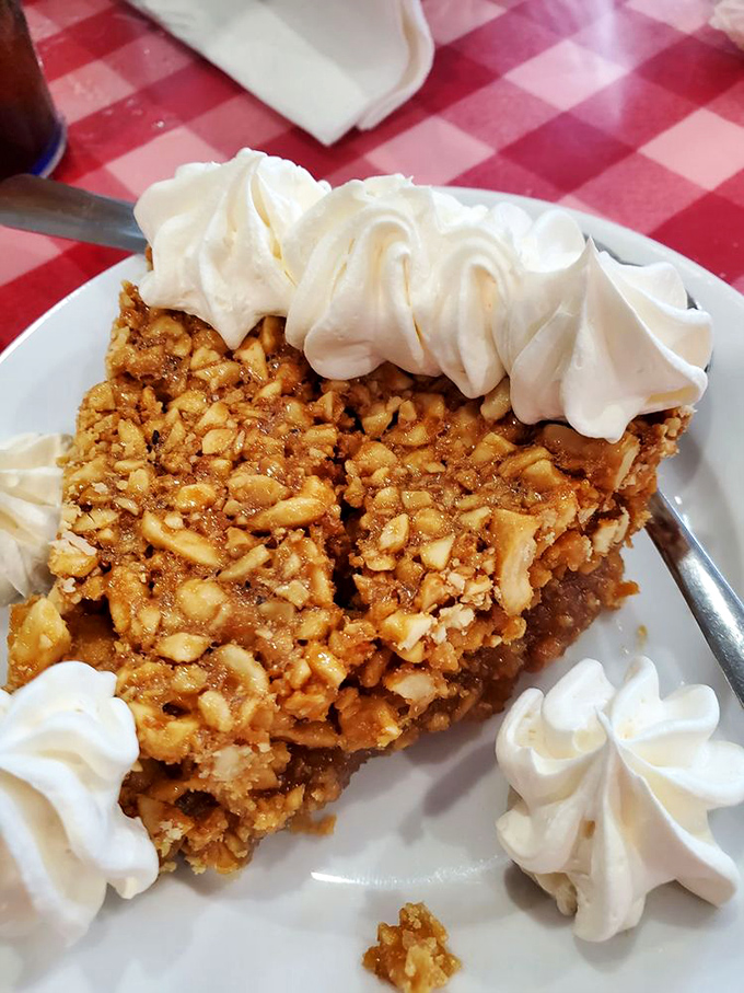 Generous chunks of peanuts suspended in caramel-like filling, surrounded by perfect crust and crowned with whipped cream. Worth every mile driven.