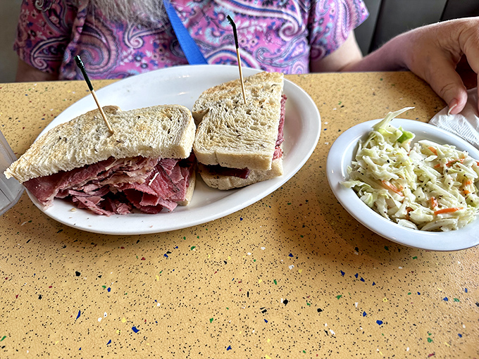 The kind of sandwich that requires both hands, several napkins, and a moment of silent appreciation before the first magnificent bite.