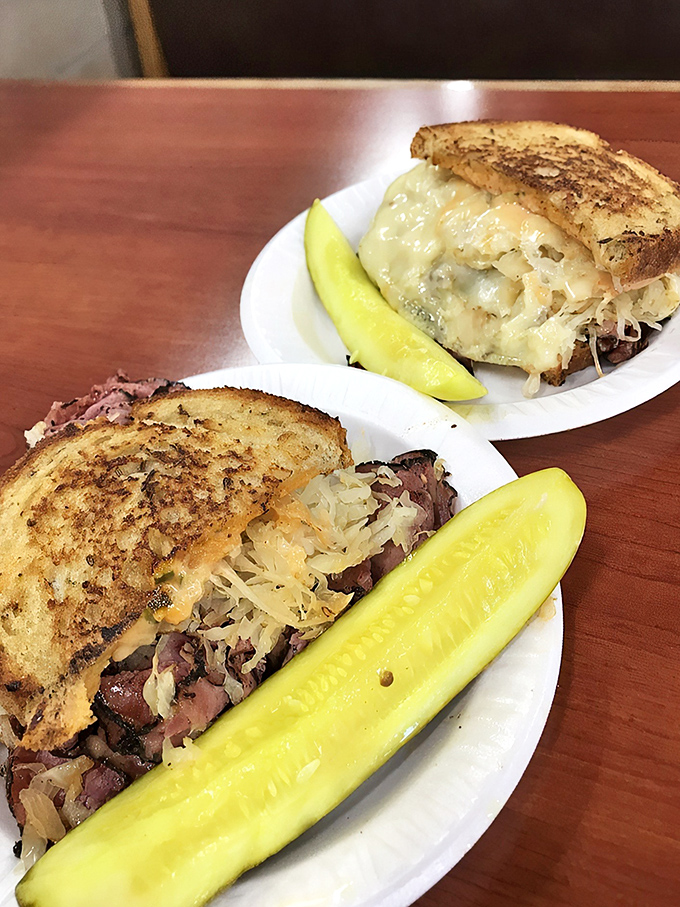Two Reubens, twice the joy. The melted Swiss cheese creates that Instagram-worthy pull that food photographers dream about. Pickle game strong.