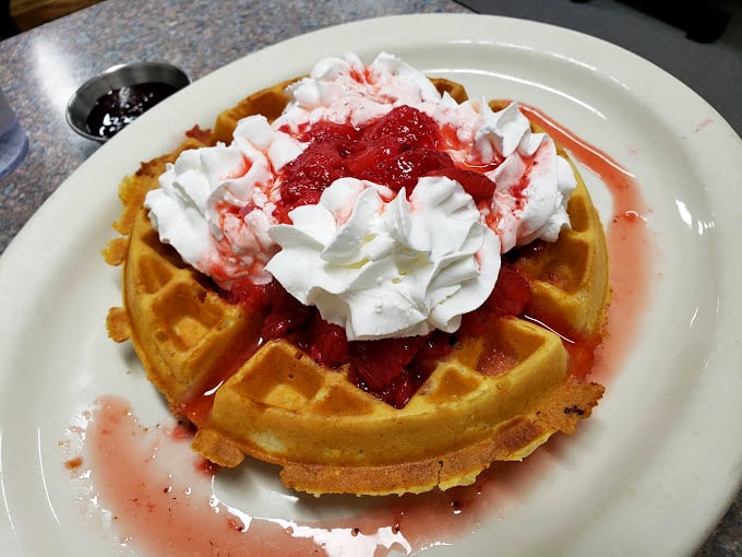 Strawberry waffles crowned with whipped cream &ndash; proof that sometimes the best things in life are exactly what you expect them to be.
