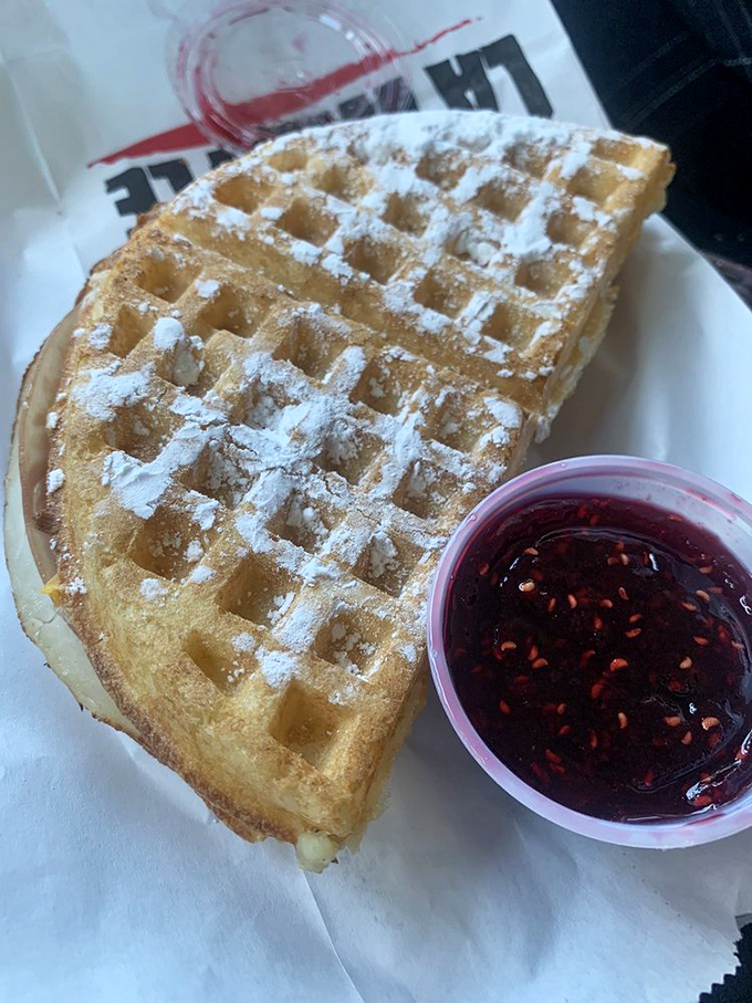 A perfect waffle with jam on the side—simple pleasures elevated to art form. Those deep squares practically beg to be filled.